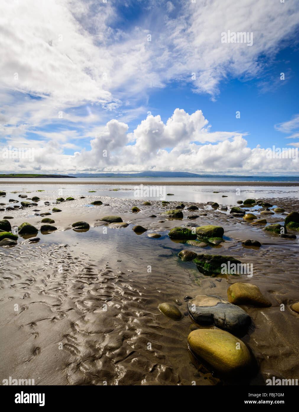 Large rocks sit on a beautiful deserted Irish beach in County Donegal ...