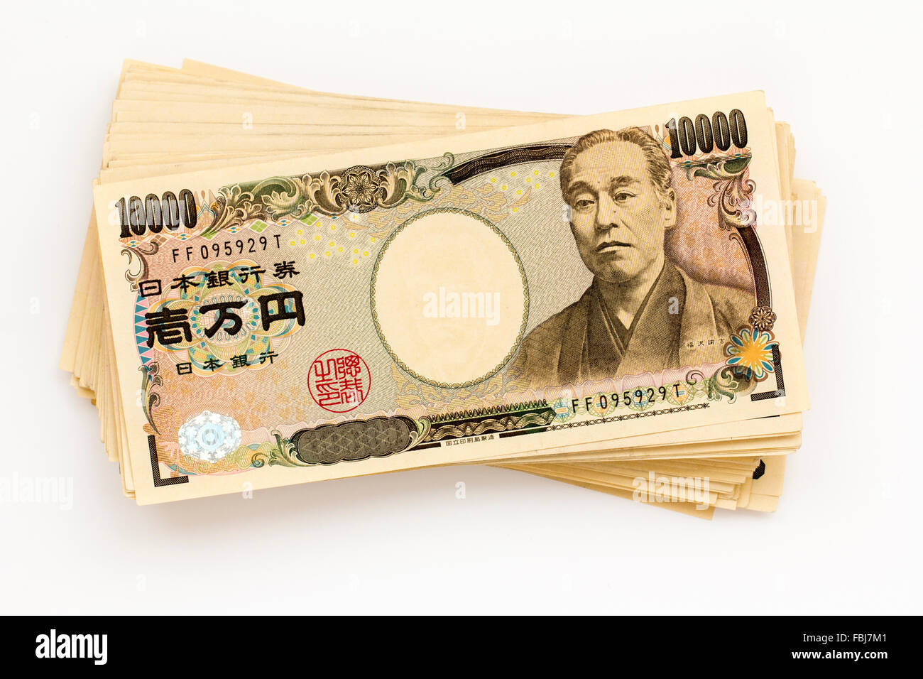 Money, currency. Pile of Japanese banknotes, 10,000 Yen, on plain white ...