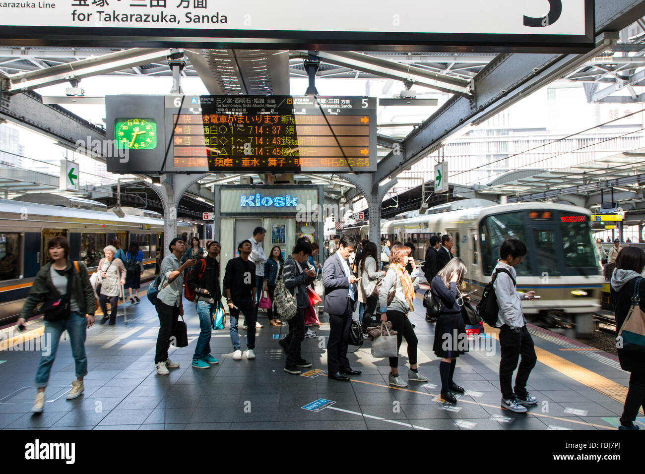 Osaka railway station. Platform 5 and 6. Two commuter trains at ...