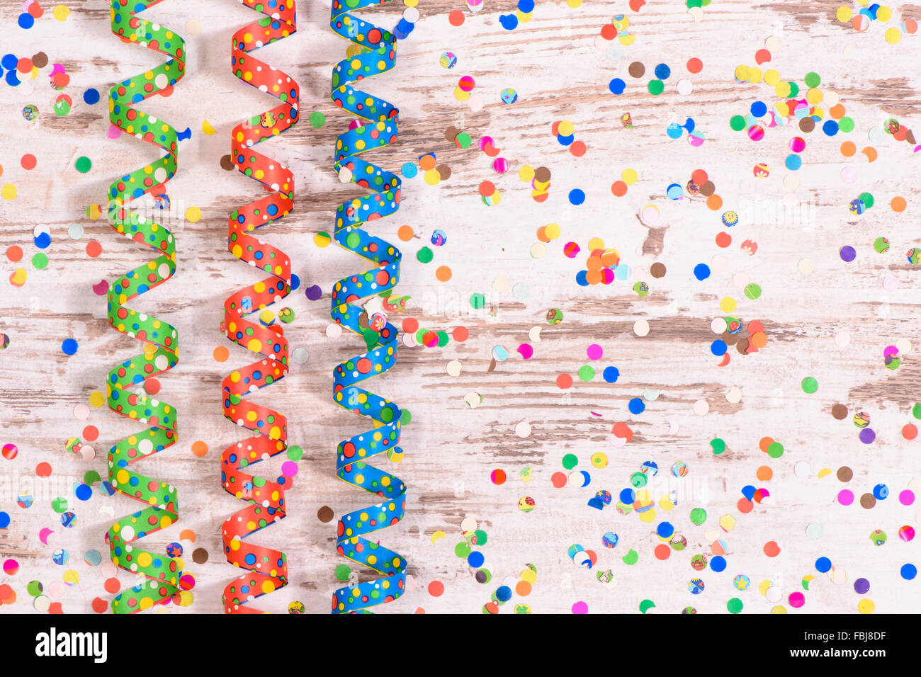 colorful paper streamer at carnival party over wooden background Stock ...