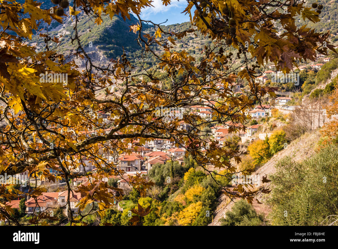 Picturesque mountain traditional village behind a tree in Arcadia ...