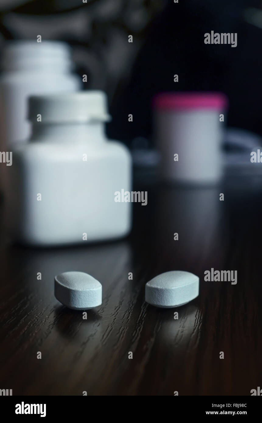 Two pills on the table Stock Photo - Alamy