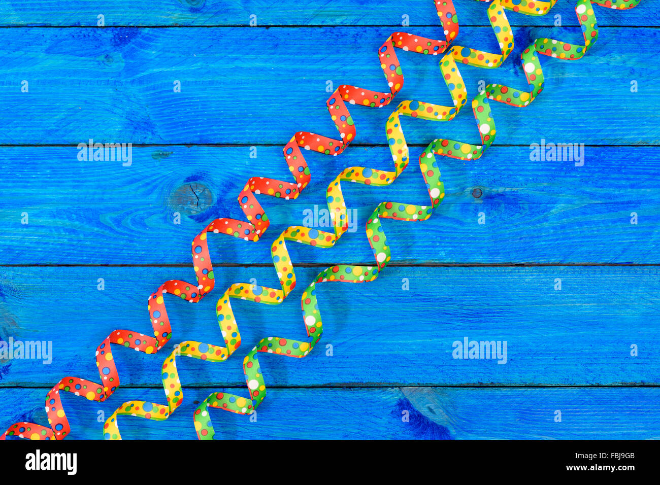 colorful paper streamer at carnival party over blue background Stock ...
