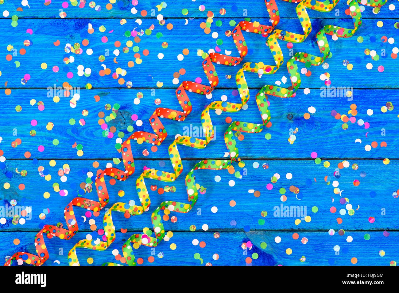 colorful paper streamer at carnival party over blue background Stock ...