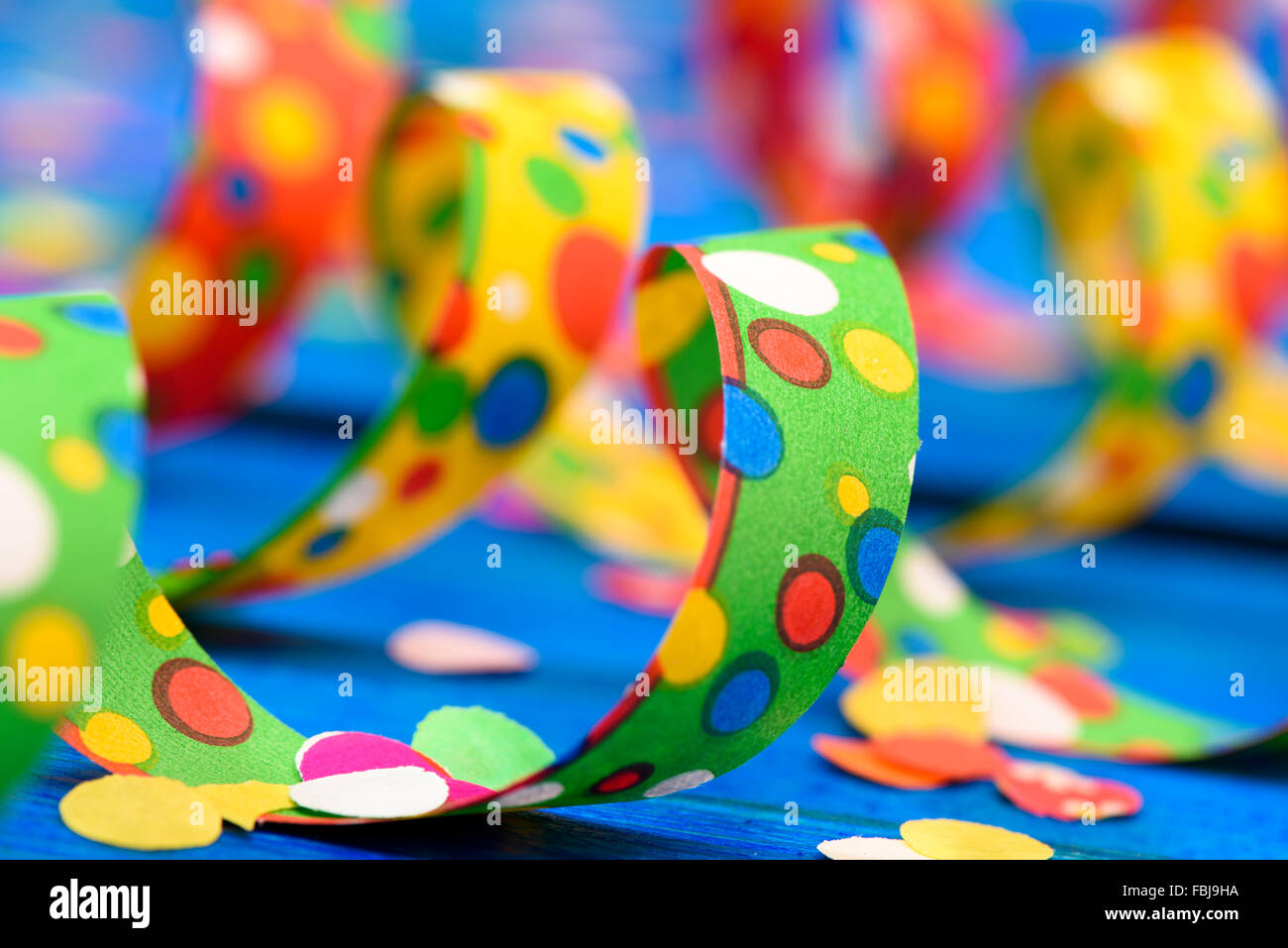 colorful paper streamer at carnival party over blue background Stock ...