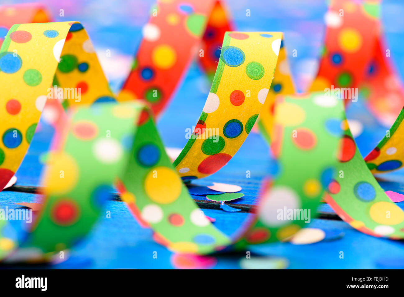 colorful paper streamer at carnival party over blue background Stock ...