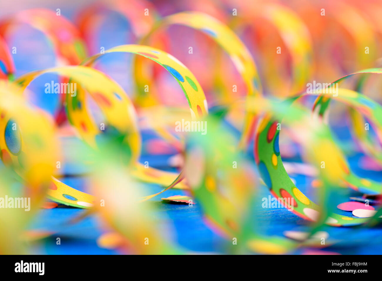 colorful paper streamer at carnival party over blue background Stock ...