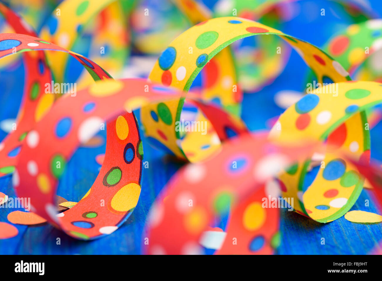 colorful paper streamer at carnival party over blue background Stock ...