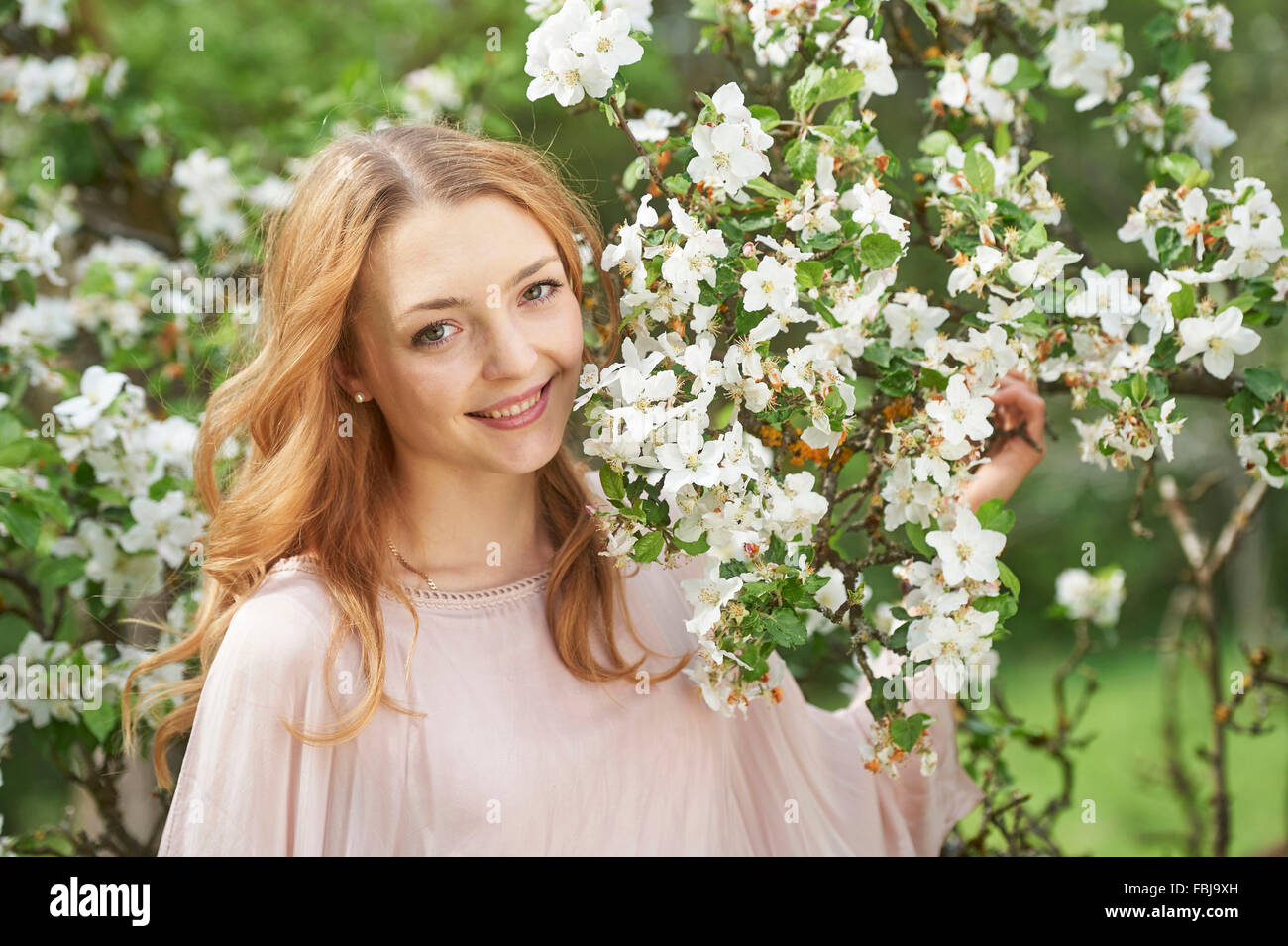 Young woman, portrait, blossoms, spring, head-on, looking at camera ...