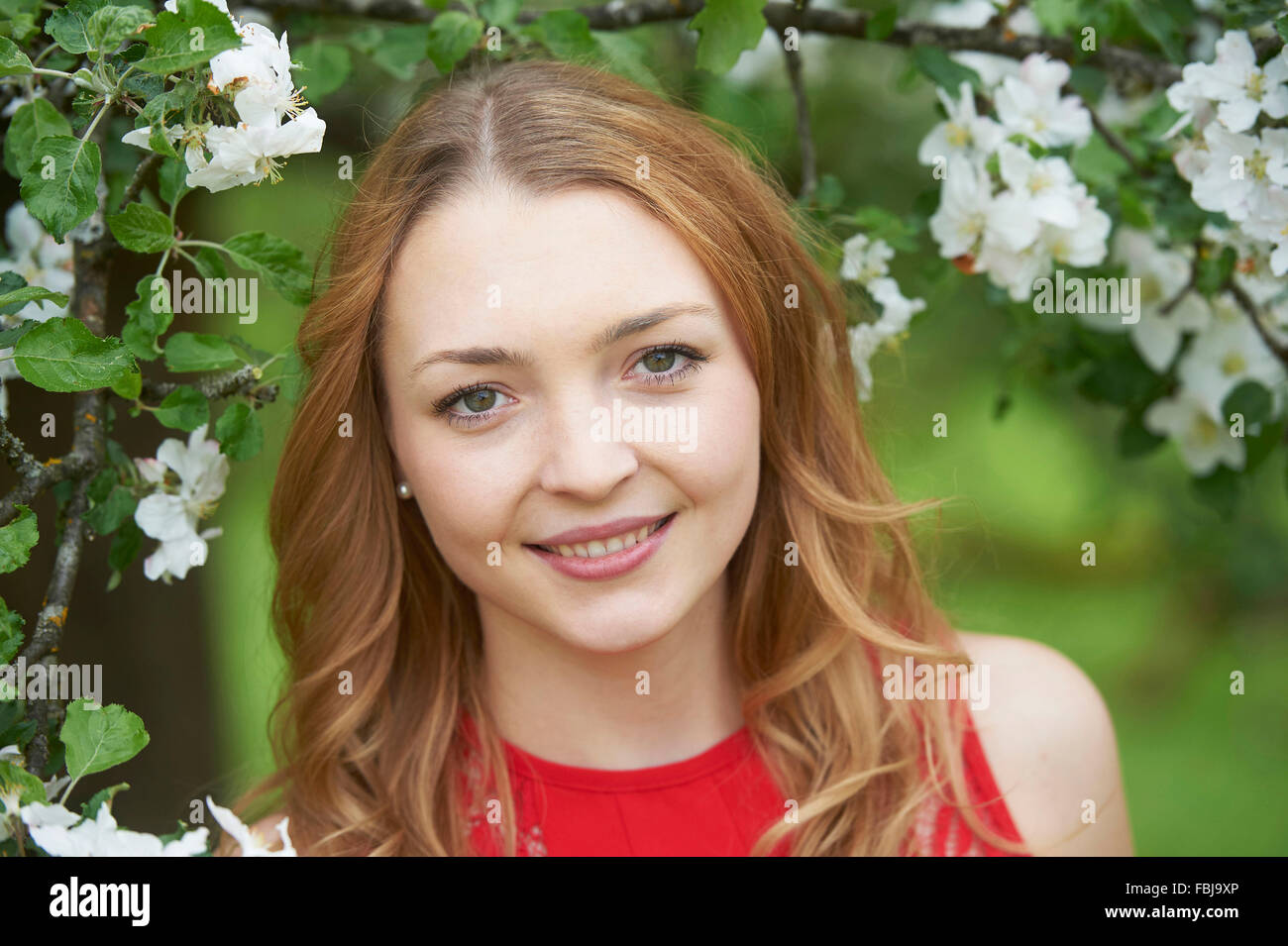 Young woman, portrait, blossoms, spring, head-on, looking at camera ...