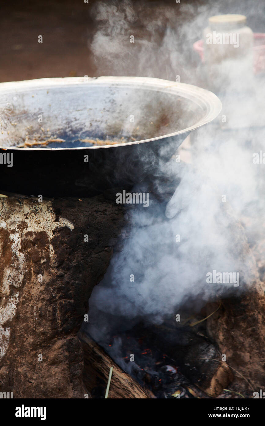 Palm sugar cooking, smoke, metal bowl, fire, Cambodia Stock Photo - Alamy