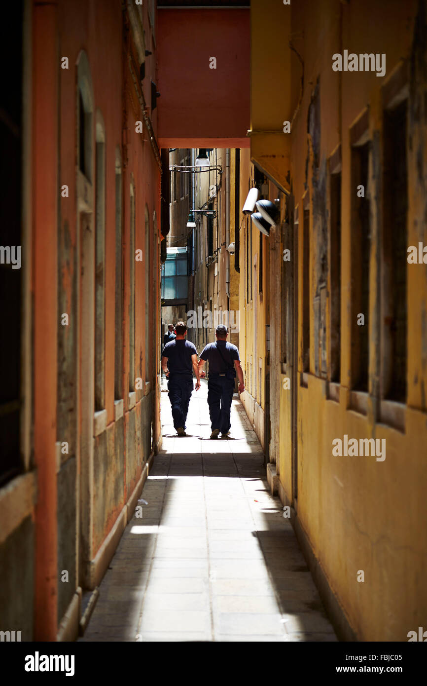 narrow lane, street in Venice, 2 men in the background, Italy Stock ...