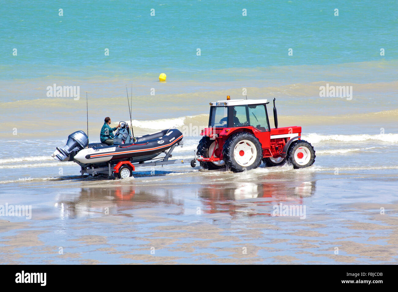 Tractor pulling rubber boat Stock Photo - Alamy