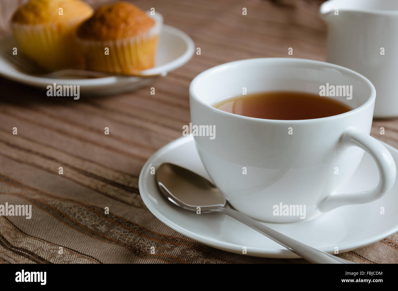 Tea and Milk with Butter Cup Cake for Tea Break Stock Photo - Alamy