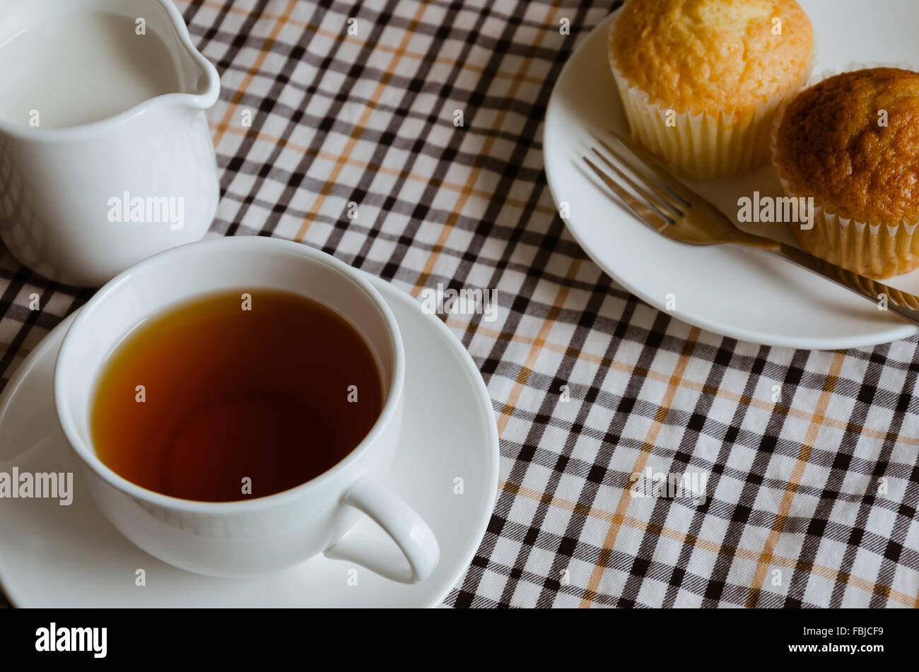 Tea and Milk with Butter Cup Cake for Tea Break Stock Photo - Alamy