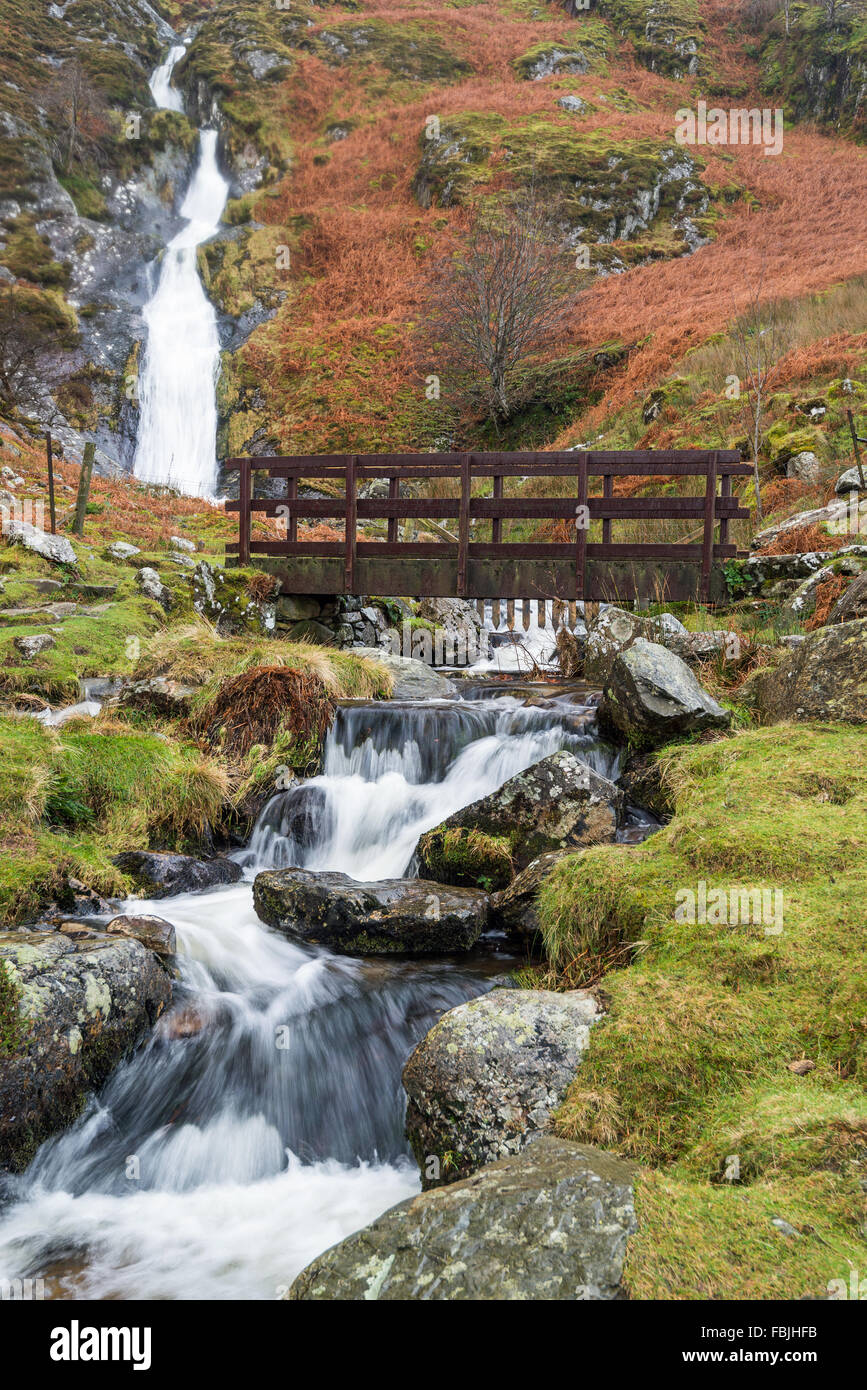 Wooden footbridge over Rhaeder Bach waterfall on the Aber River in ...