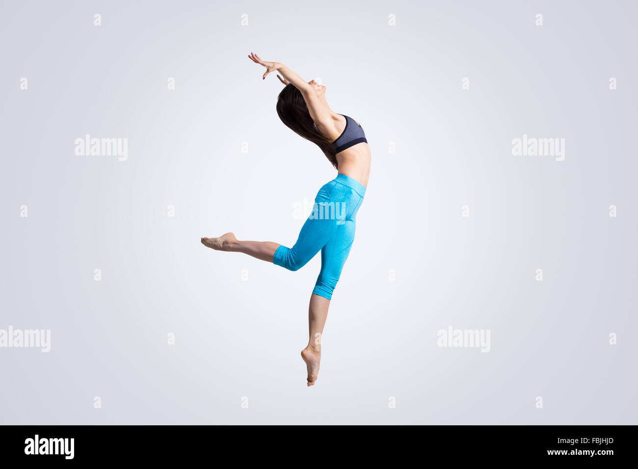 One beautiful young fit modern dancer lady in blue sportswear warming ...