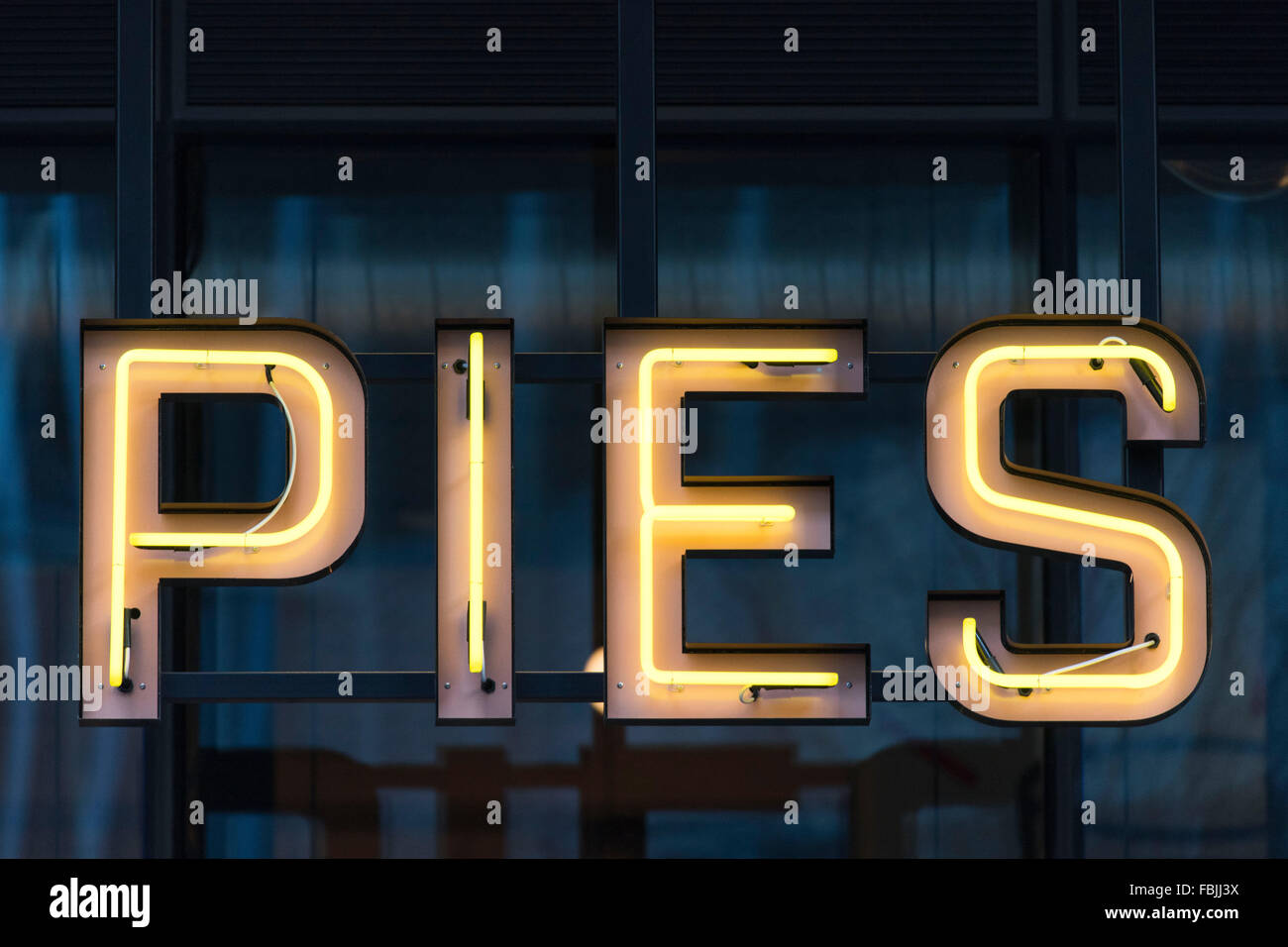 A neon sign that reads Pies Stock Photo - Alamy