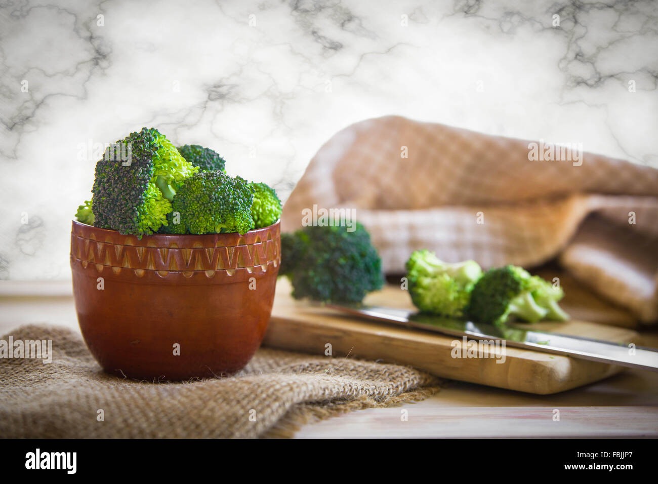 Broccoli with knife in and cutting board Stock Photo - Alamy