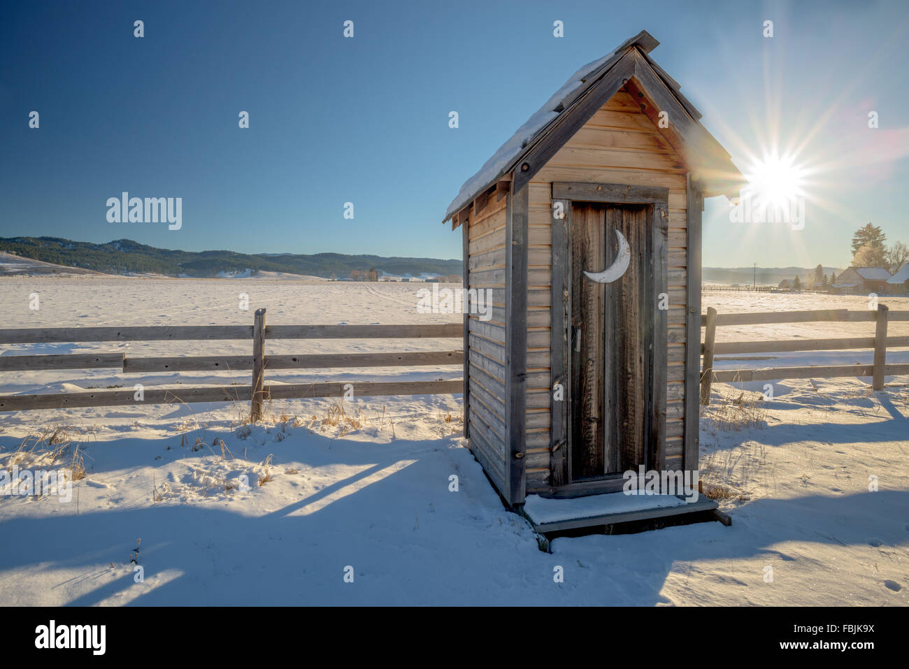 Old wood outhouse in winter with sun star Stock Photo - Alamy