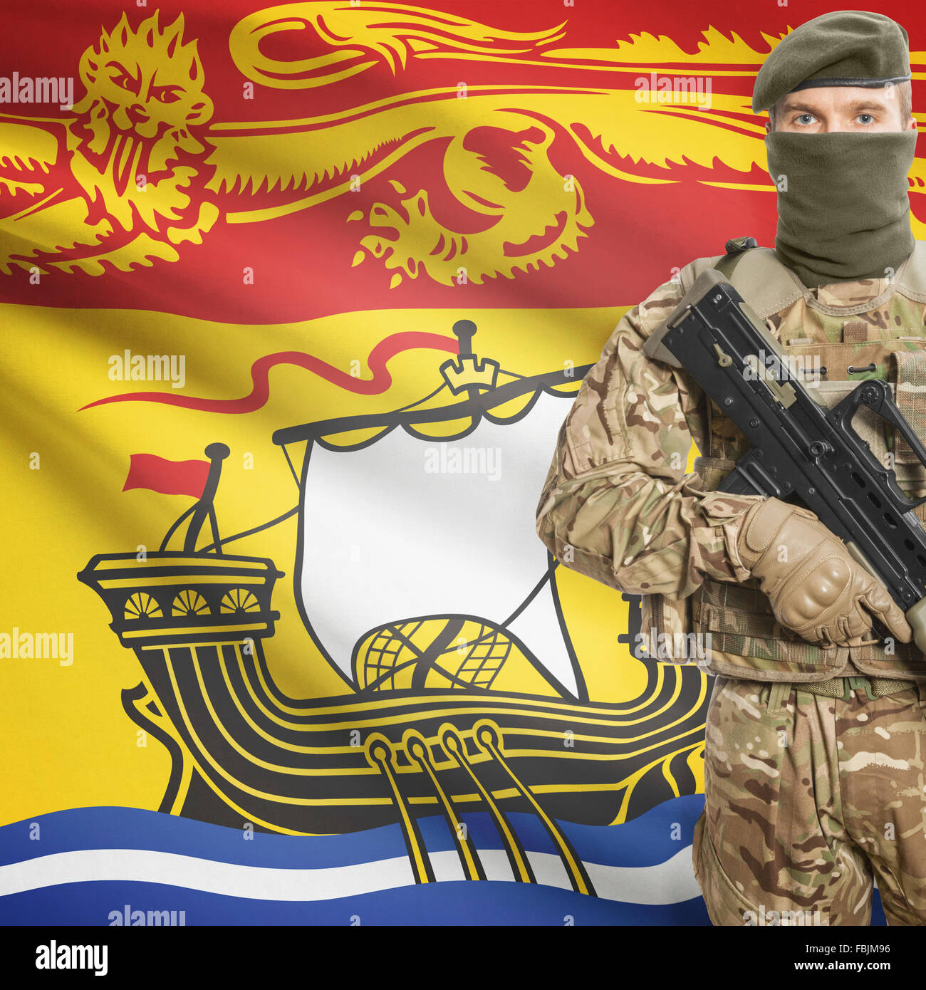 Soldier with machine-gun in hands and Canadian province flag on ...