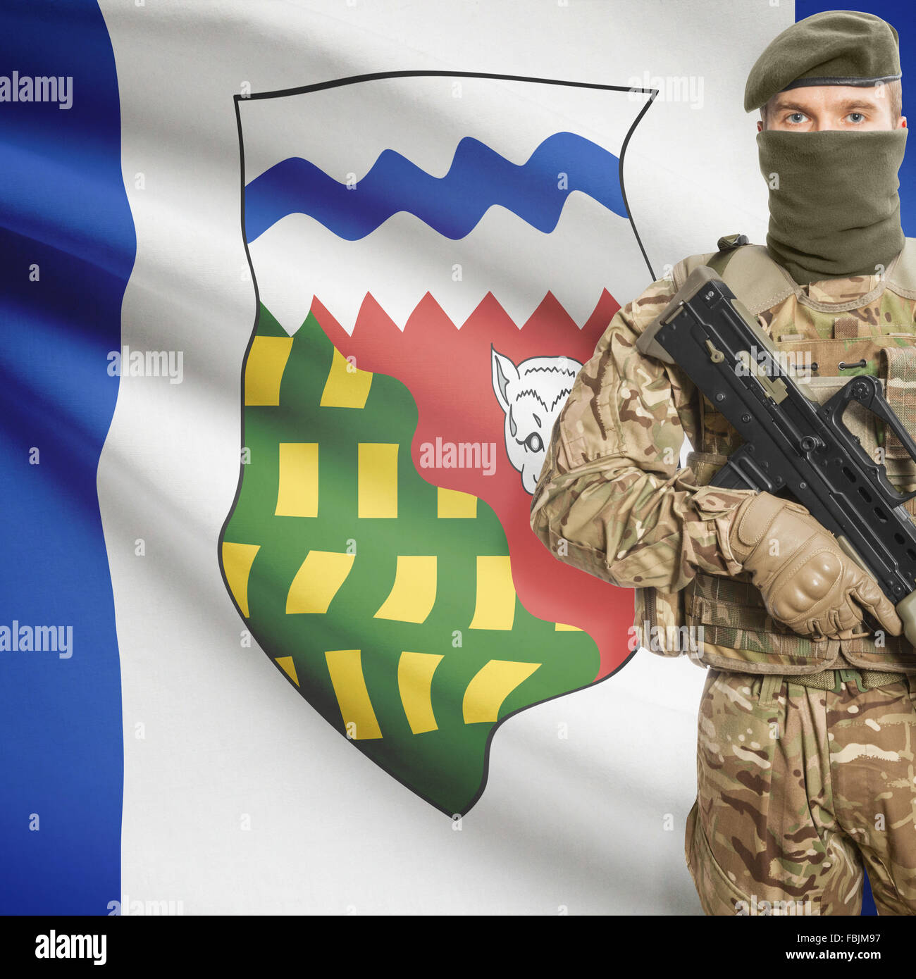 Soldier with machine-gun in hands and Canadian province flag on ...