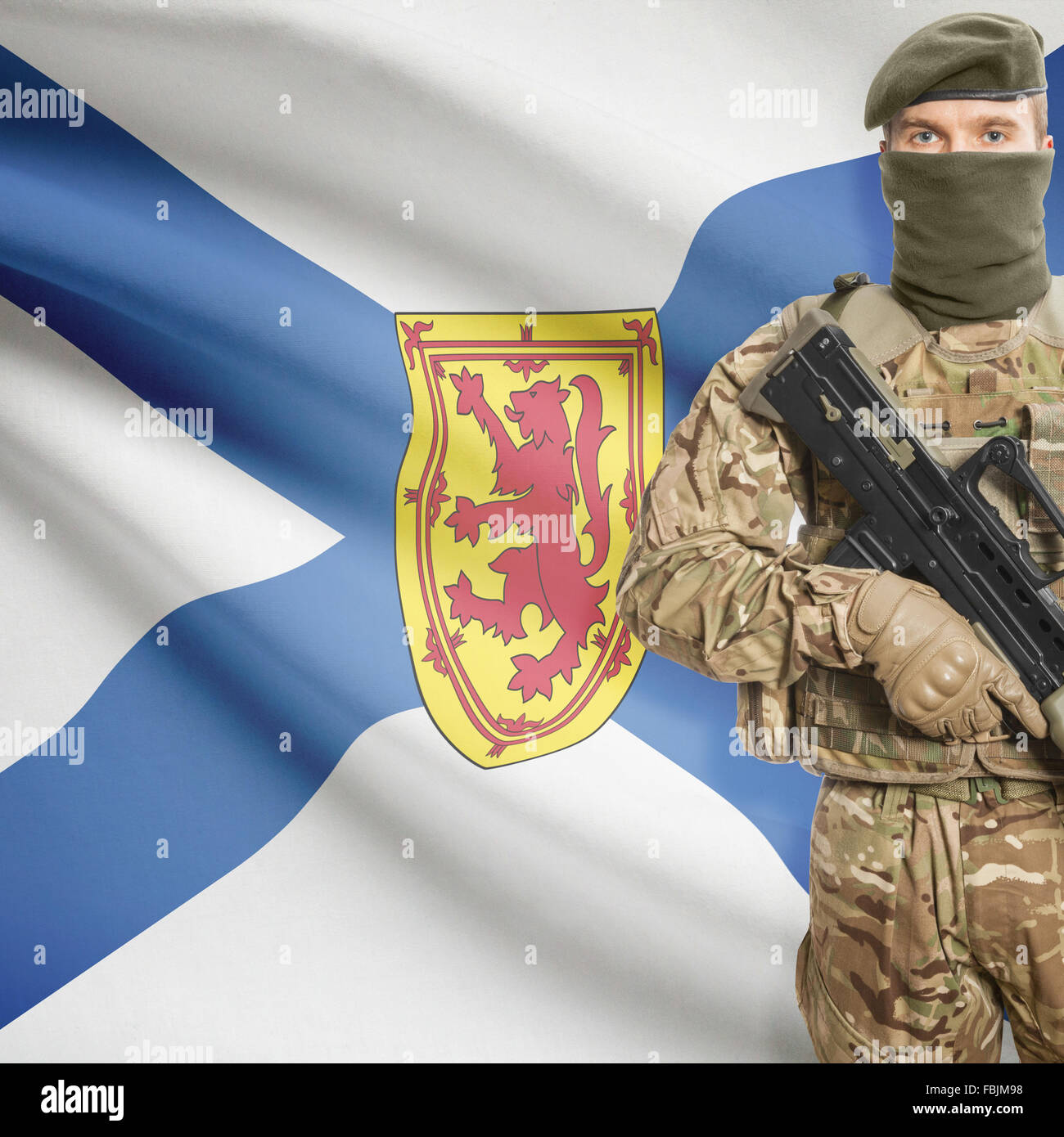 Soldier with machine-gun in hands and Canadian province flag on ...