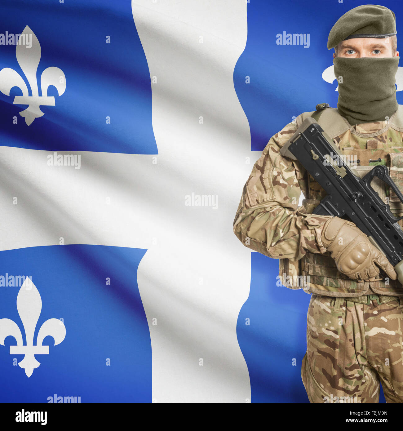 Soldier with machine-gun in hands and Canadian province flag on ...
