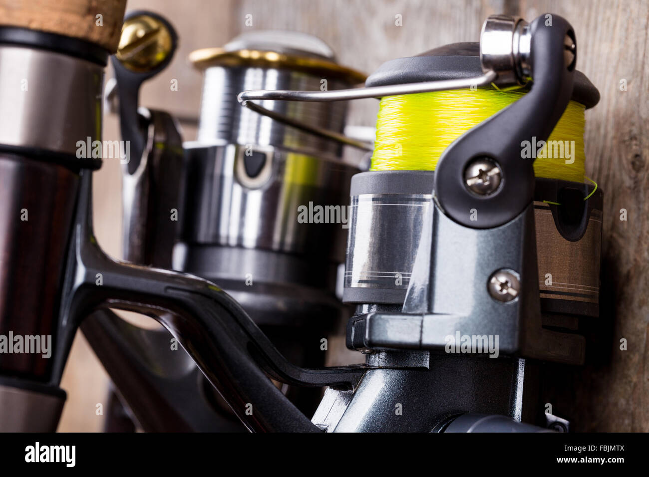 closeup fishing reel with line on wooden board background Stock Photo ...