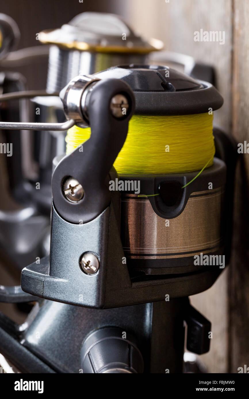 closeup fishing reel with line on wooden board background Stock Photo ...
