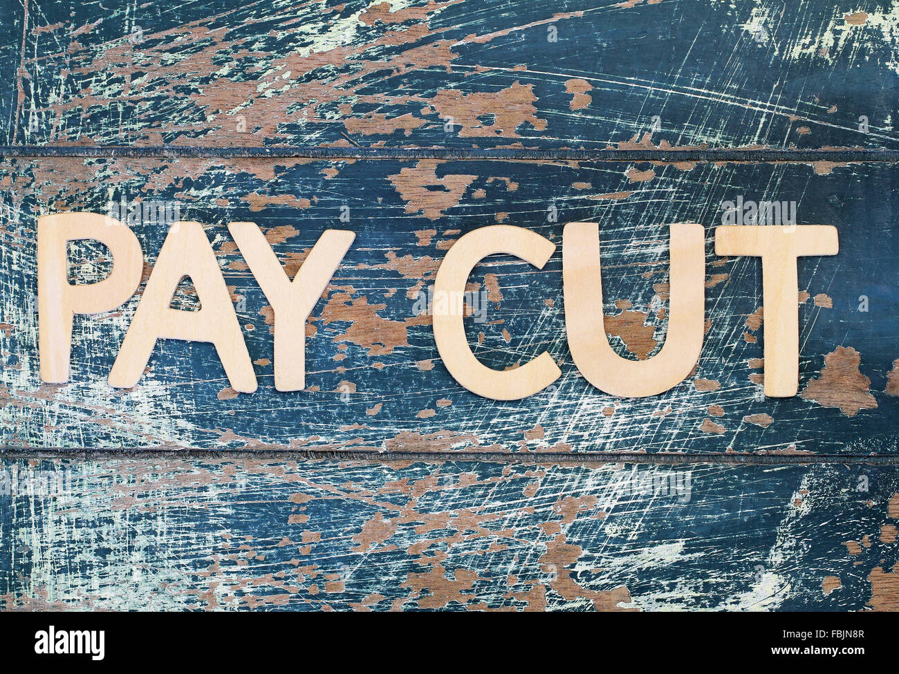 Pay cut written with wooden letters on rustic surface Stock Photo - Alamy