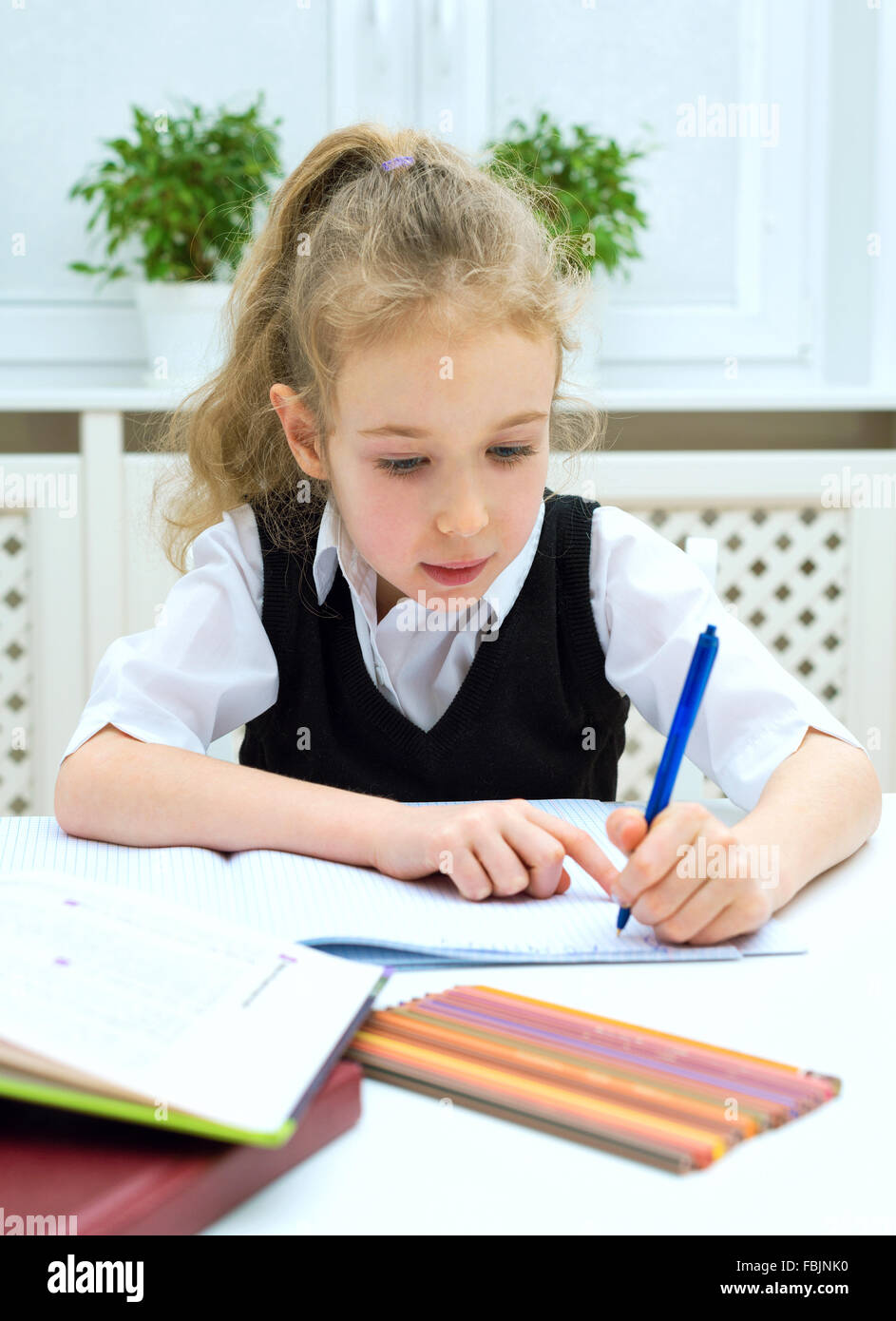 Little girl doing her homework at home Stock Photo - Alamy