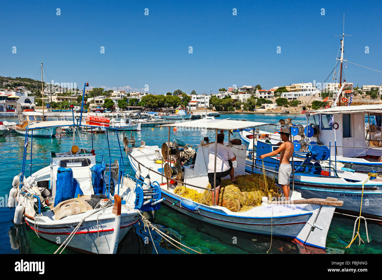 Fishermen with net at the port of Souvala in Aegina island, Greece ...