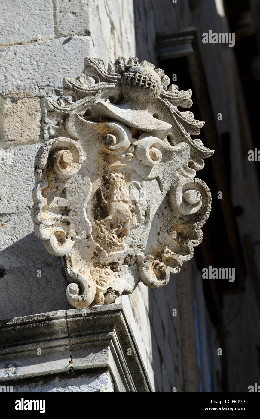 A stone carving Code of Arms on a building wall in the Old Town ...