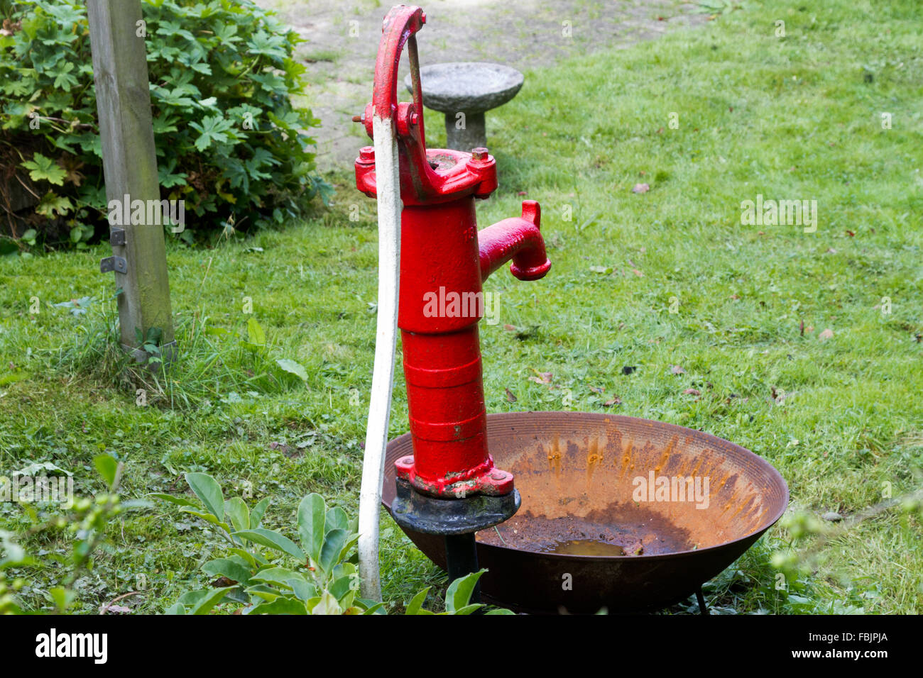 Bright red water pump outdoors Stock Photo - Alamy