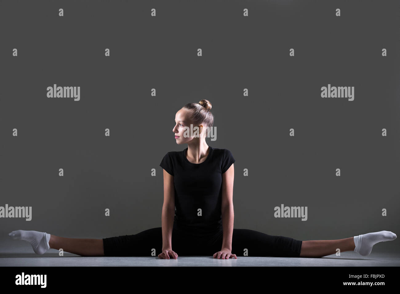 Beautiful cool young fit woman in sportswear doing art gymnastics ...