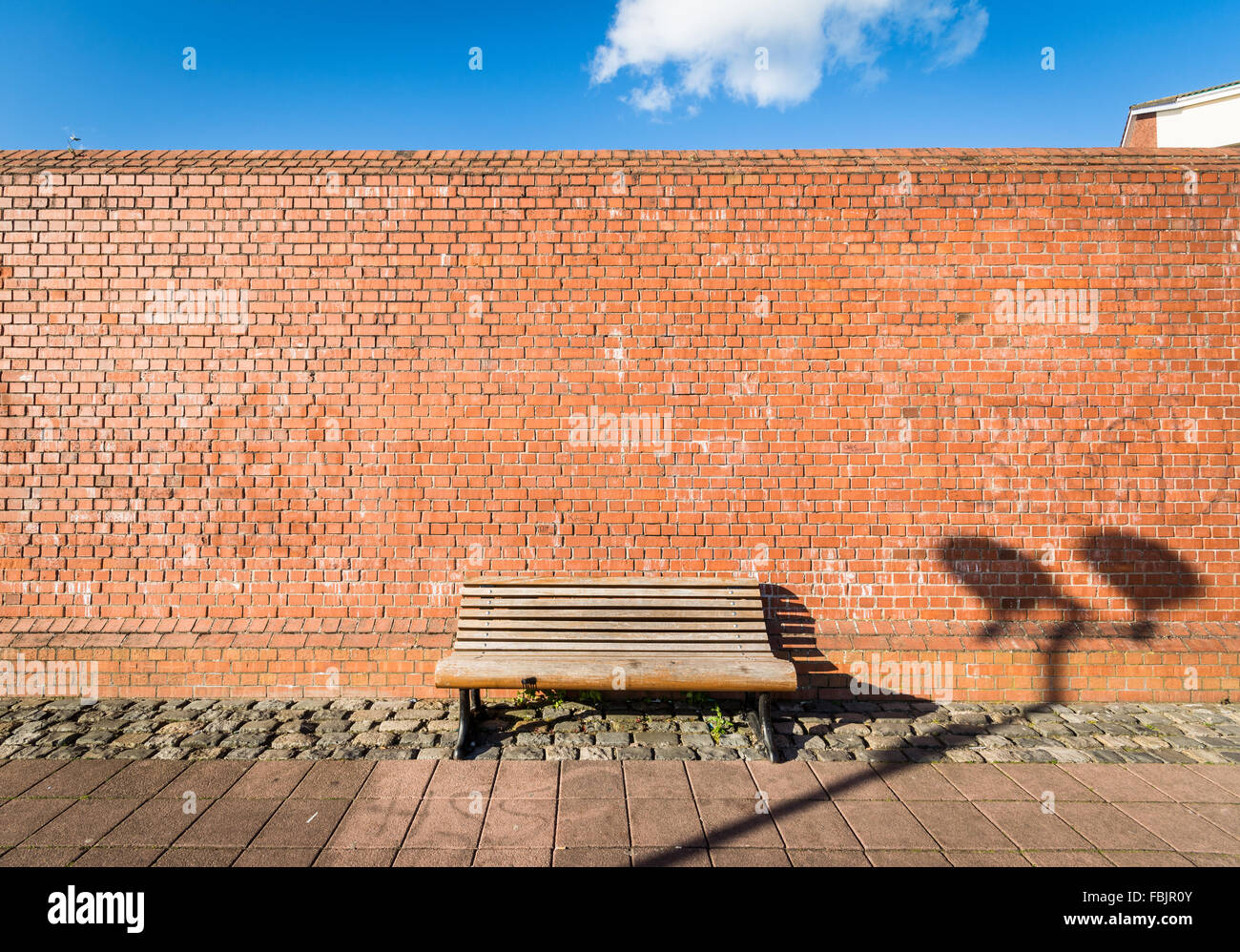 Wooden bench against wall hi-res stock photography and images - Alamy
