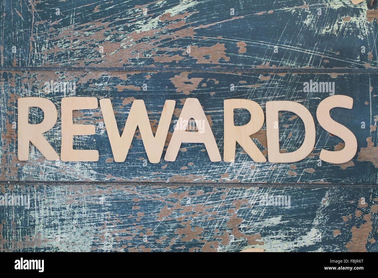 Word rewards written with wooden letters on rustic surface Stock Photo ...