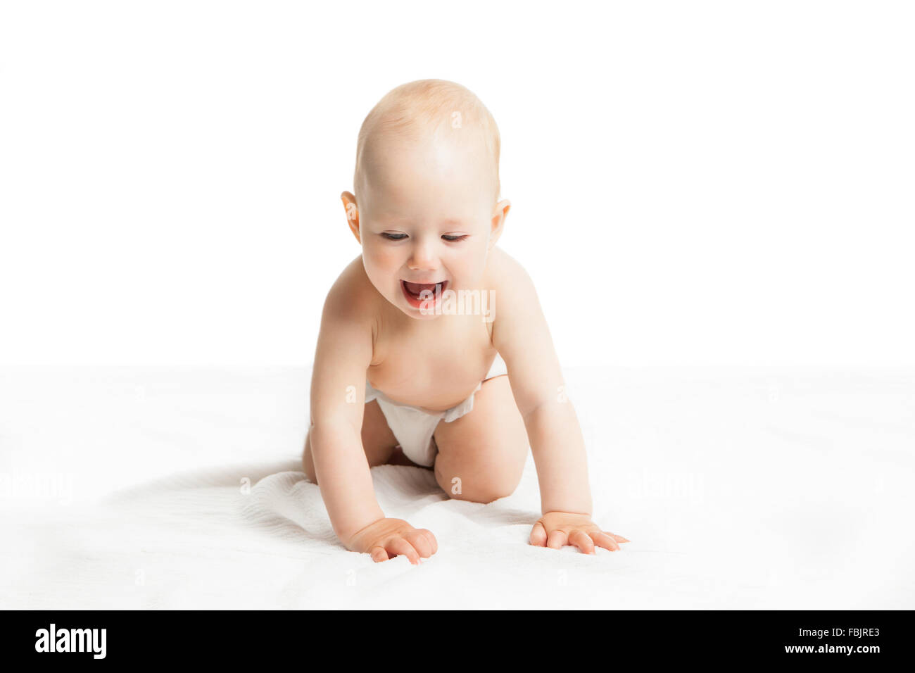 Adorable baby sitting over white background Stock Photo - Alamy