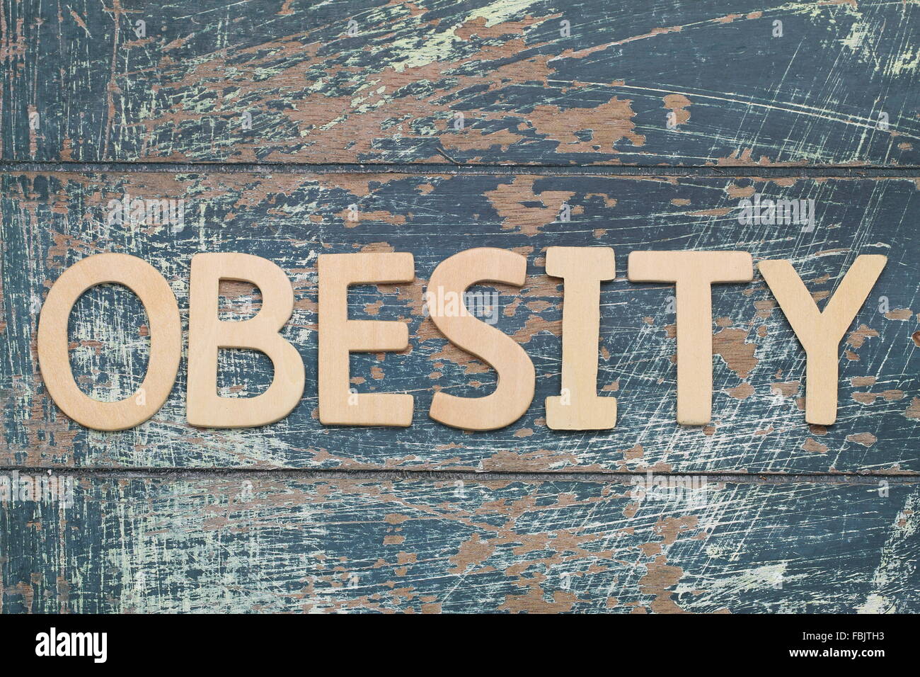 Word obesity written with wooden letters on rustic surface Stock Photo ...