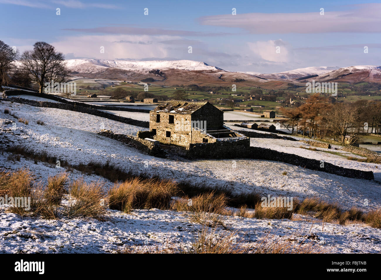 Traditional Yorkshire Dales barns with the market town of Hawes and a ...