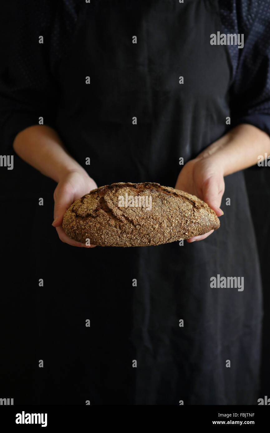 Hands holding loaf bread in hi-res stock photography and images - Alamy