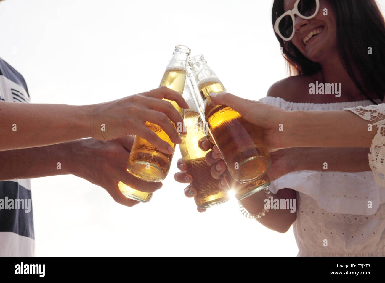 Happy young friends drinking beer outdoors Stock Photo - Alamy