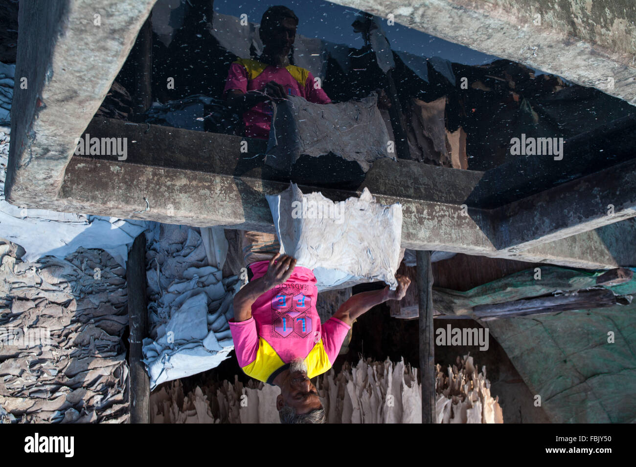 DHAKA, BANGLADESH 11th January 2016: A worker washing leather using ...