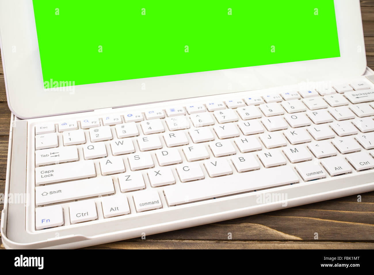 Open laptop isolated screen on old wooden desk Stock Photo - Alamy