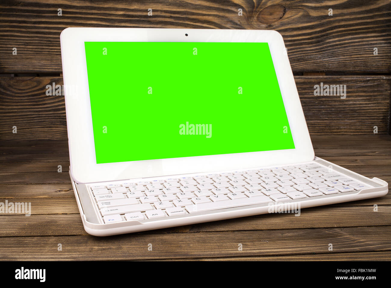 Open laptop isolated screen on old wooden desk Stock Photo - Alamy