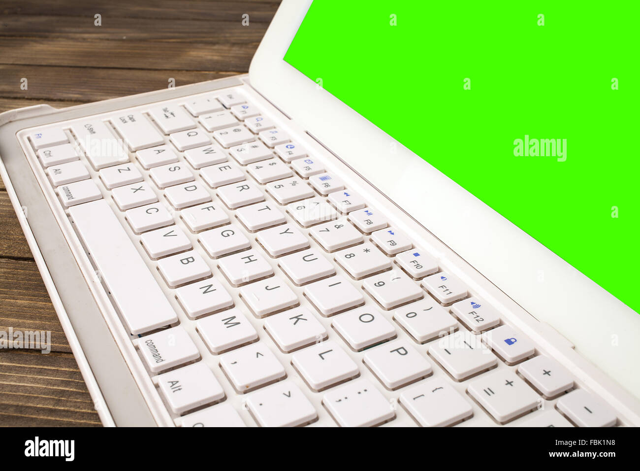 Open laptop isolated screen on old wooden desk Stock Photo - Alamy