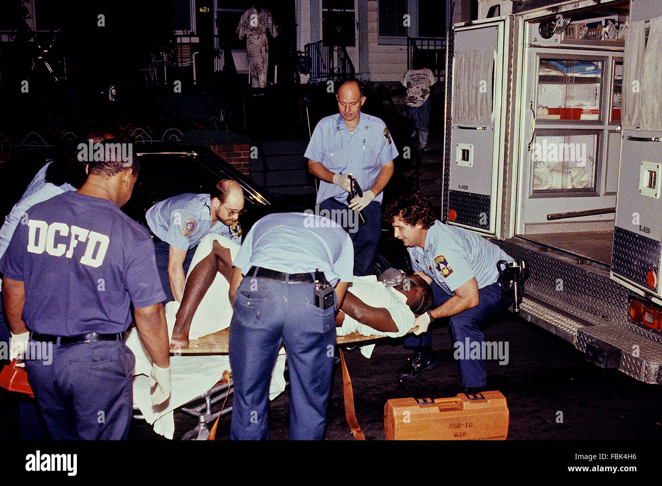Washington, DC., USA, 1990 DC. Paramedics load man into an ambulance ...