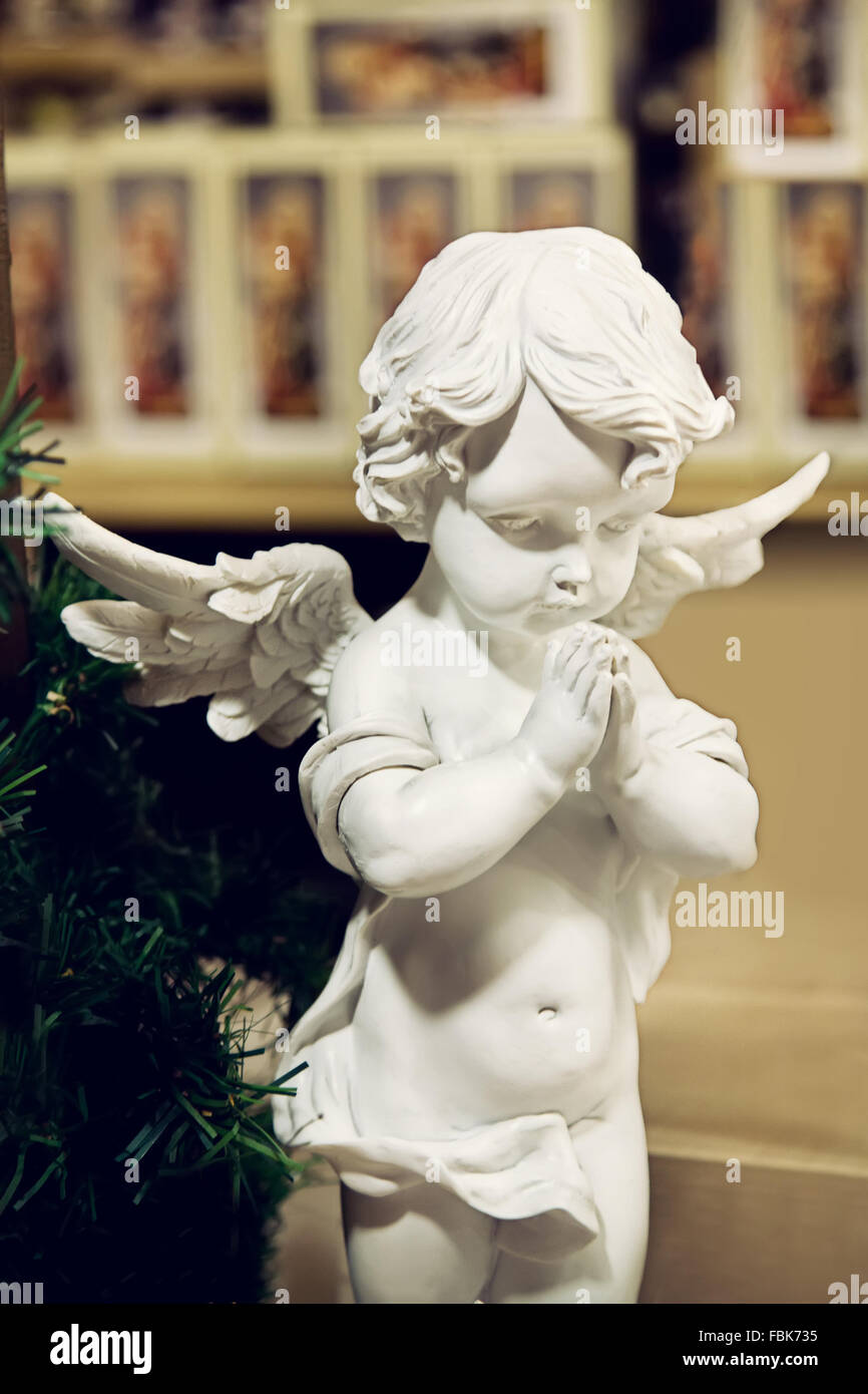 White figurine of an angel puts his hands together Stock Photo - Alamy