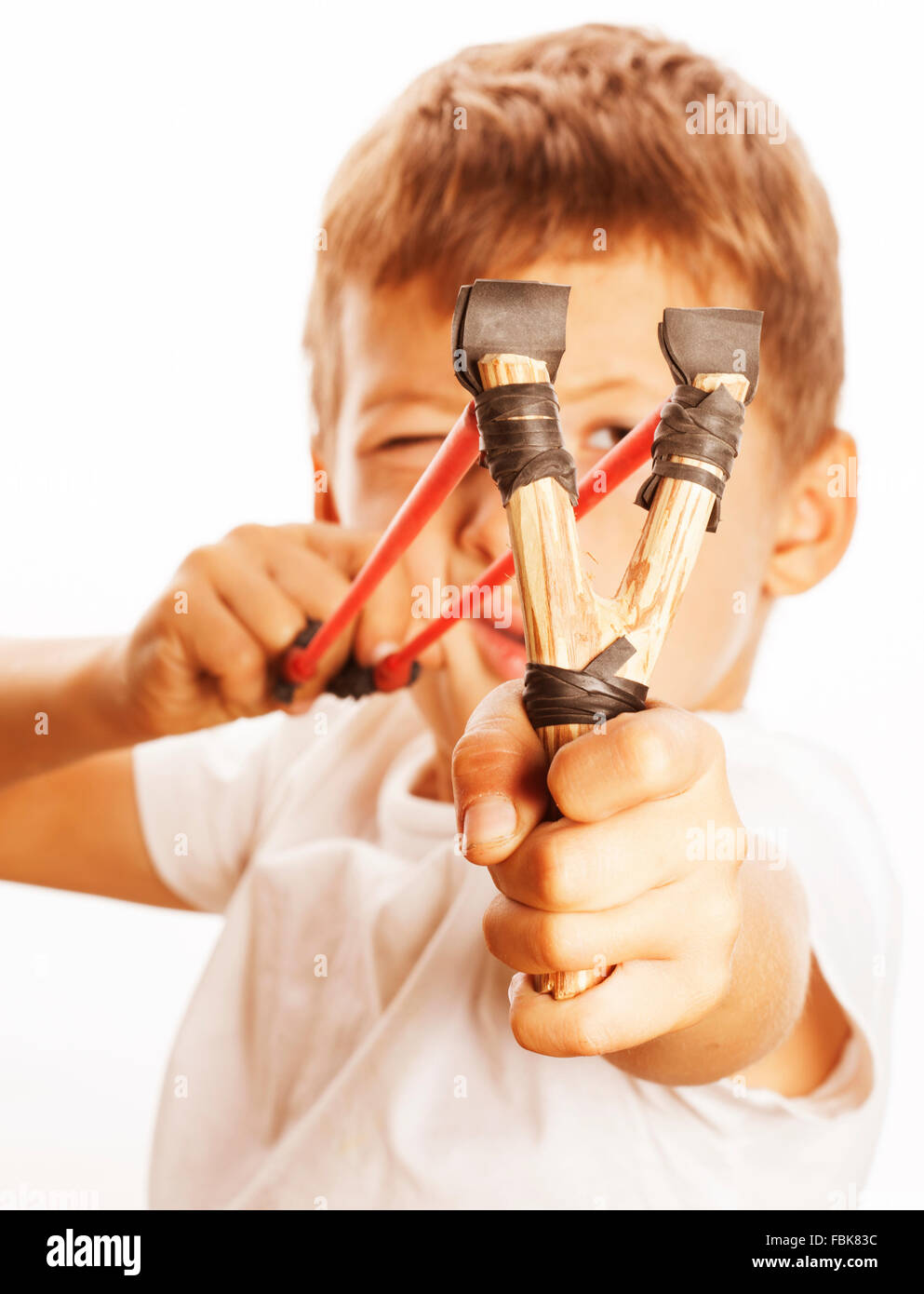 little cute angry real boy with slingshot isolated Stock Photo - Alamy